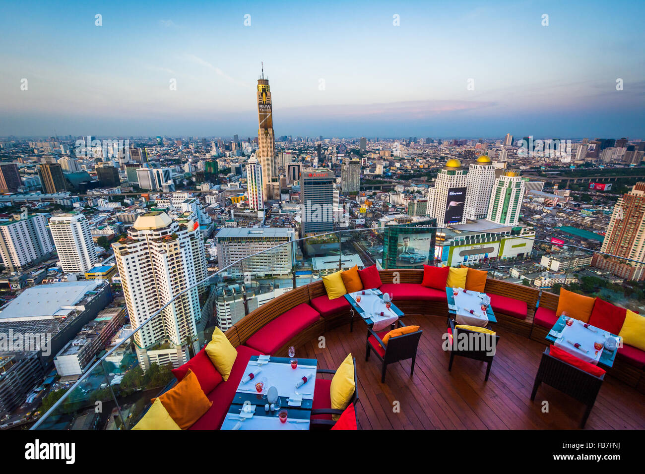 View of modern skyscrapers in Siam at sunset, from a rooftop restaurant ...