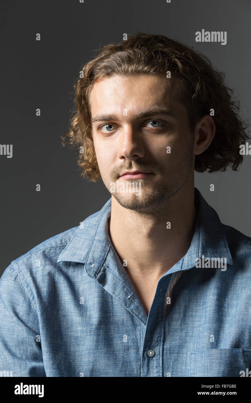 Portrait of confident man against black background Stock Photo - Alamy