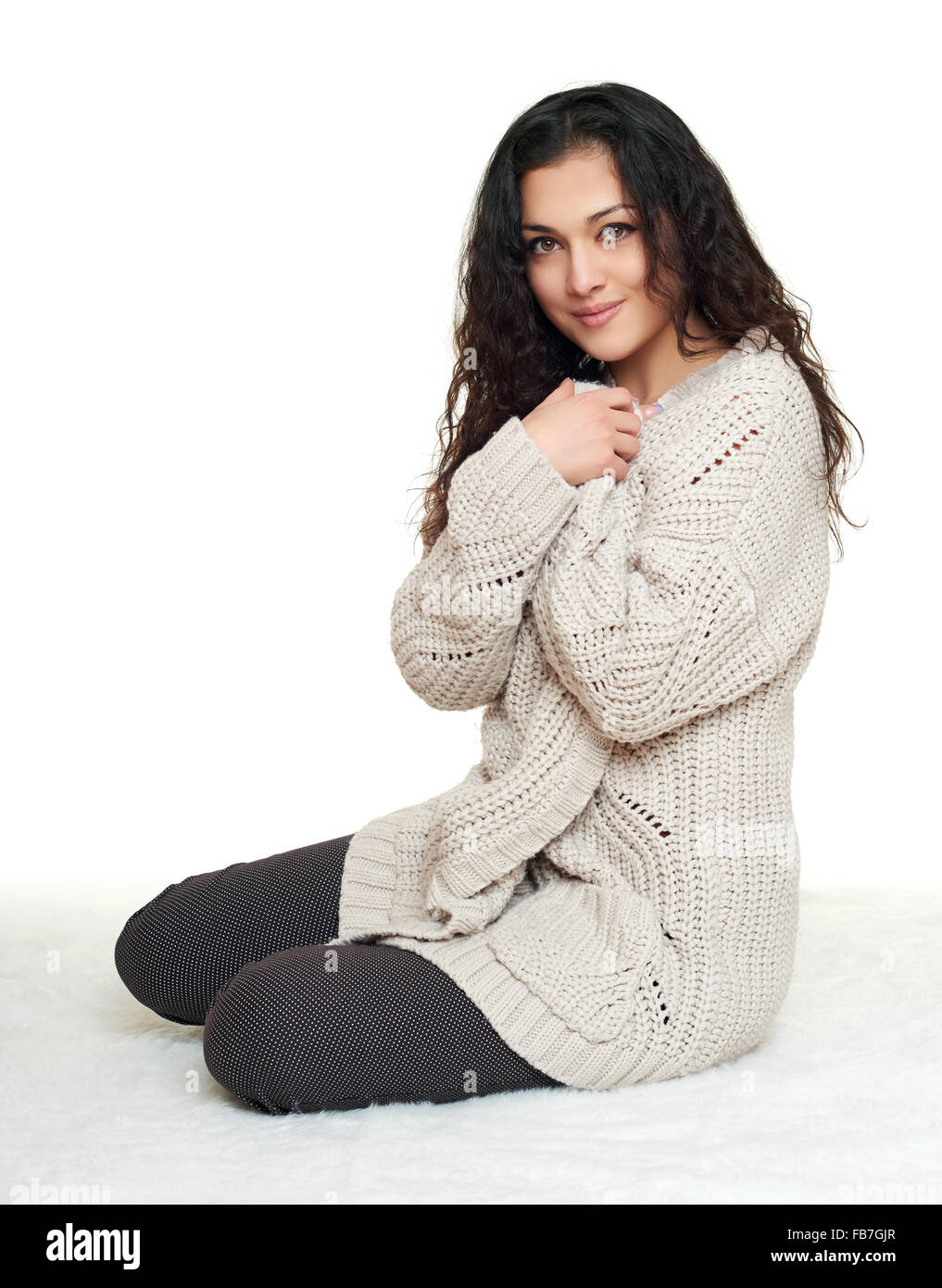 girl portrait in homelike dress sit on fur floor, white background ...