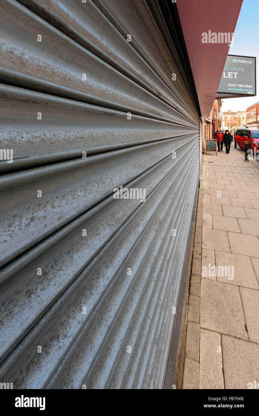 A closed and shuttered high street shop along station Road in Hinckley ...