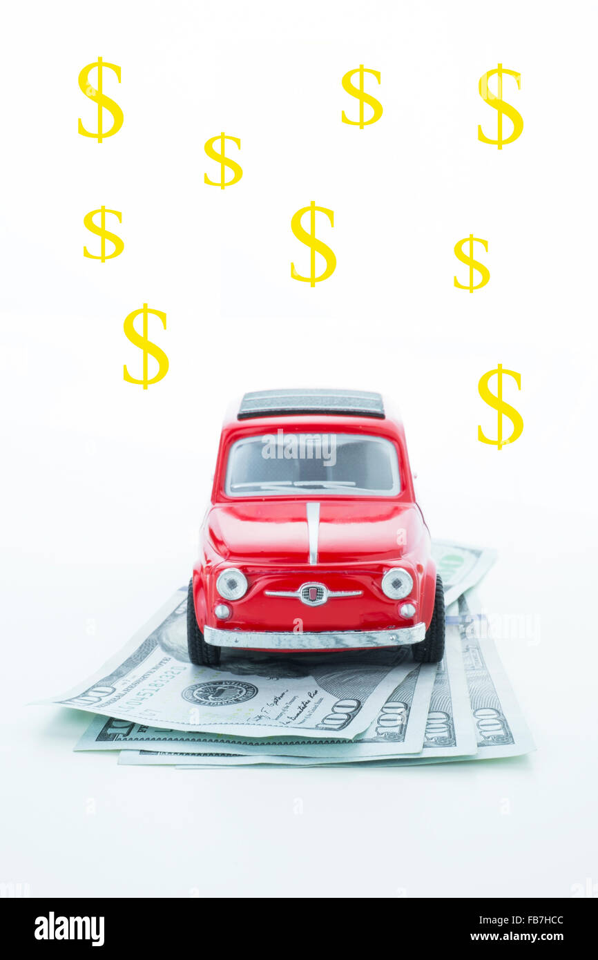 A car driving on a road paved with money, symbolising the road to ...