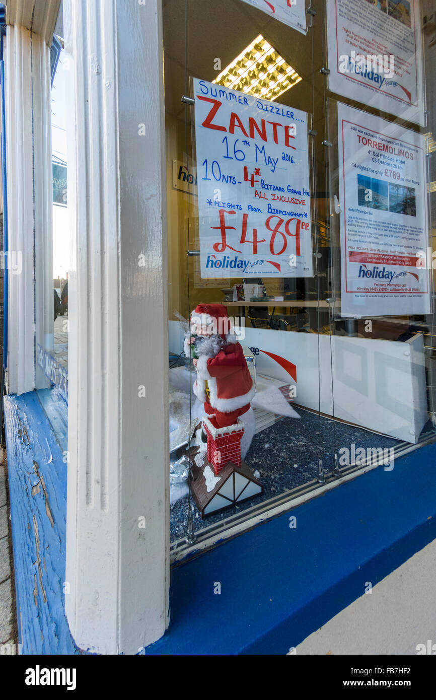 Santa in the shop window of a Travel Agent Stock Photo - Alamy