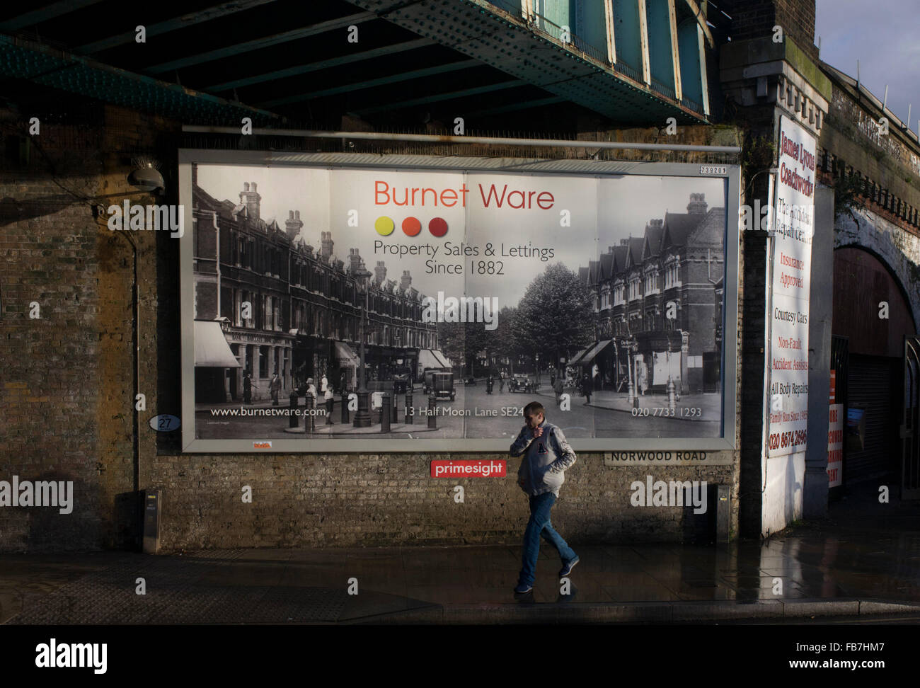 Property estate agent's billboard showing old street scene under ...