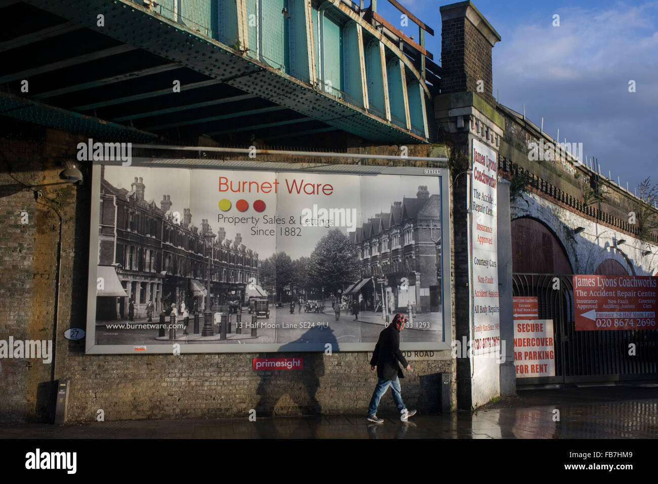 Property estate agent's billboard showing old street scene under ...