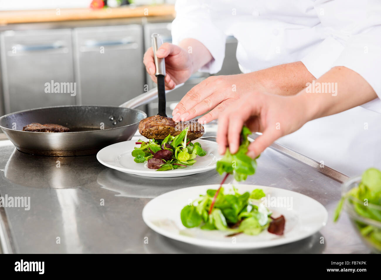 Professional chefs prepares steak dishes at restaurant Stock Photo - Alamy