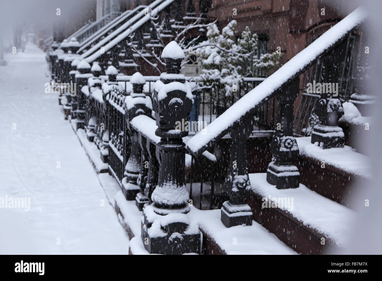 Snow covered Brooklyn Heights brownstone townhouse stoops and sidewalk ...