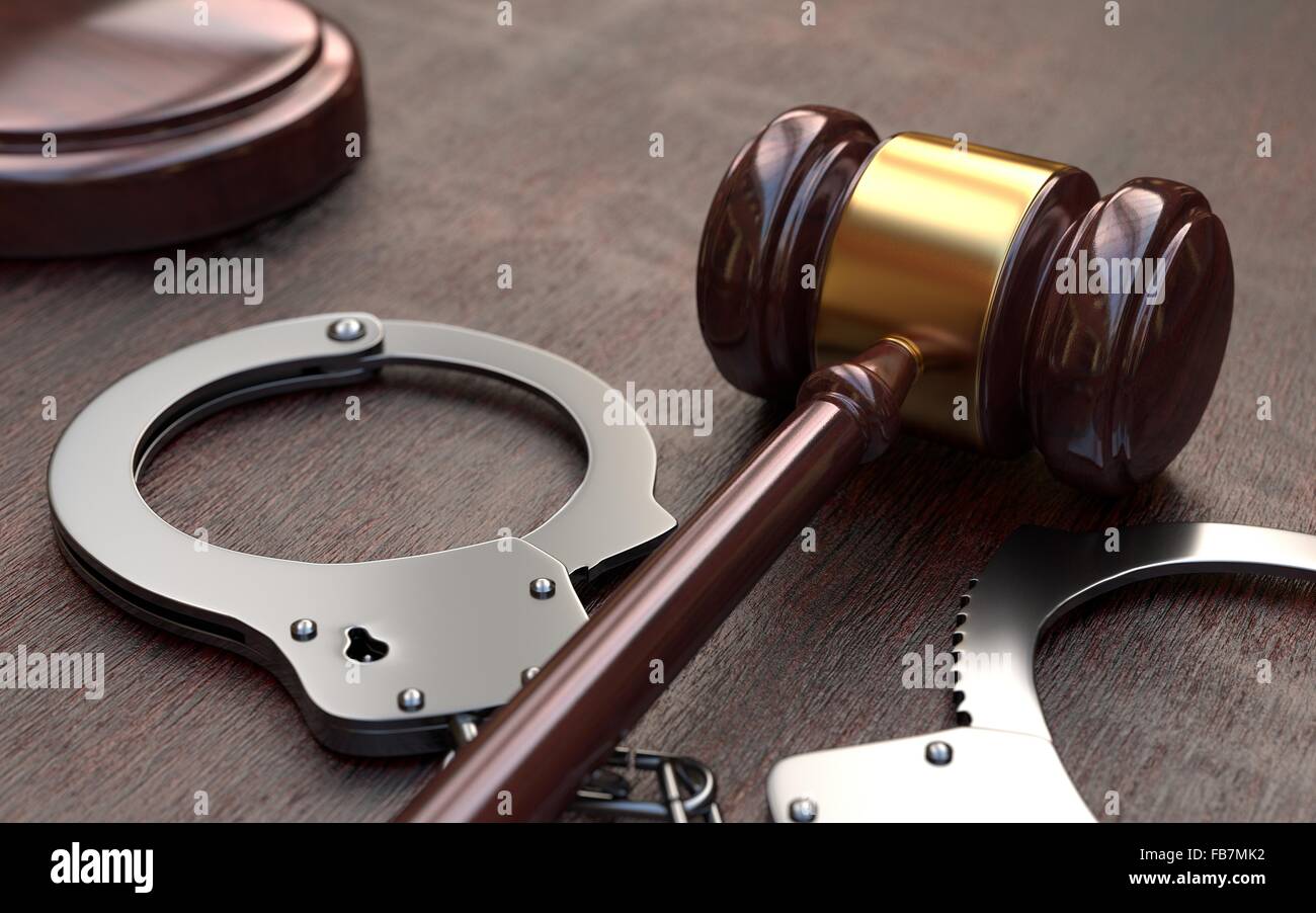 Gavel and handcuffs on wooden, brown table background Stock Photo - Alamy