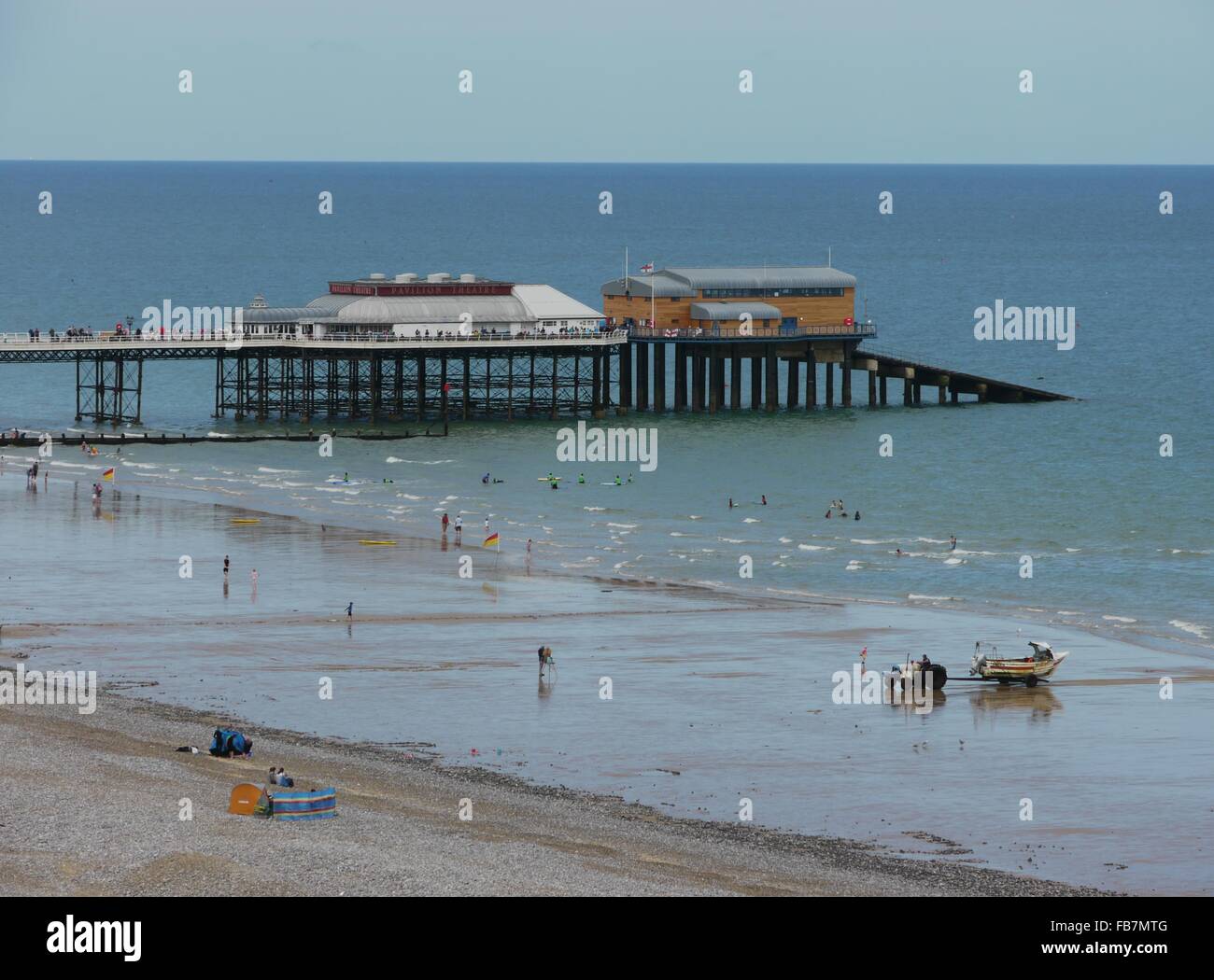 Cromer Pier at low tide with a tractor towing in a fishing boat Stock ...