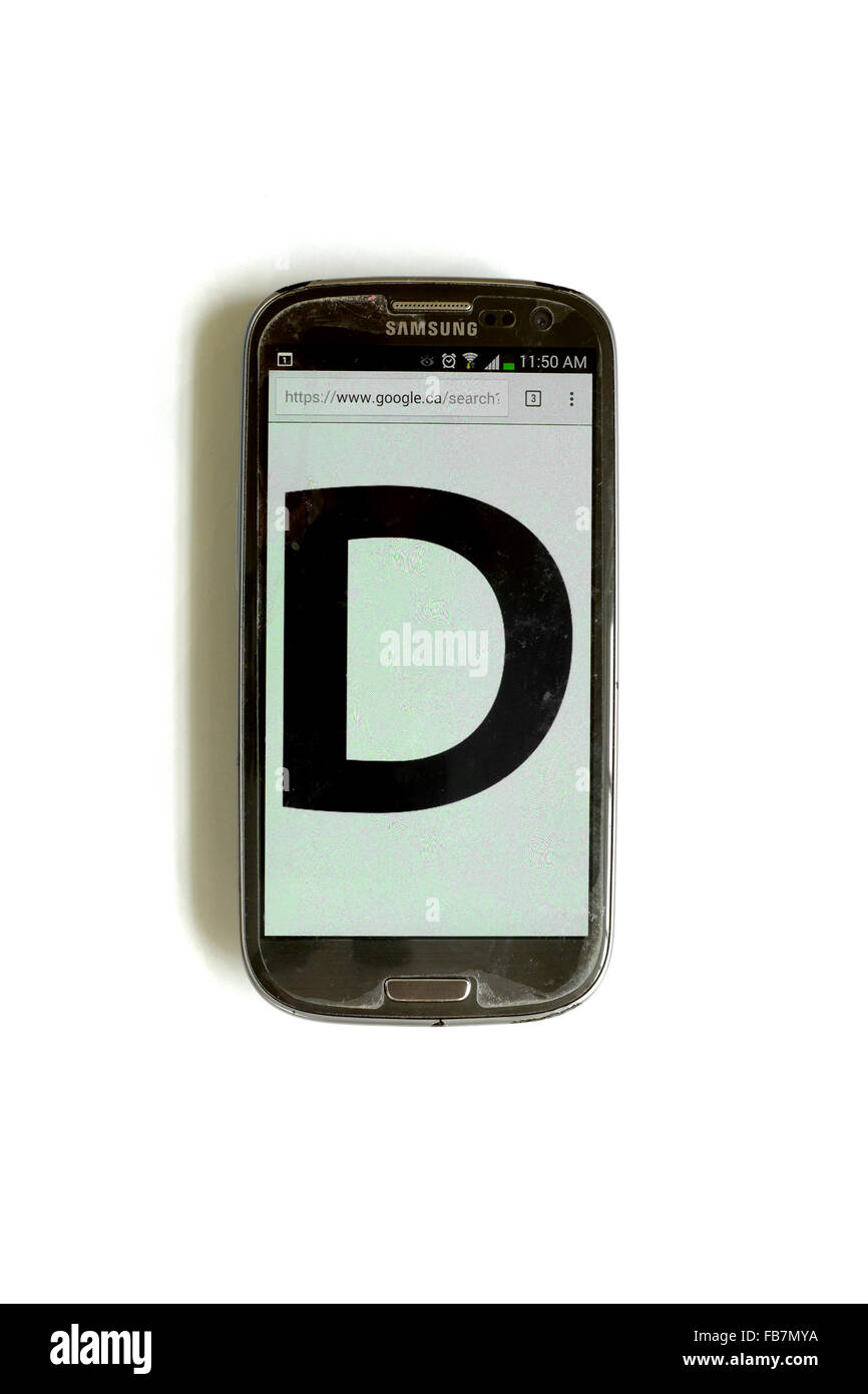 The letter D written on the screen of a smartphone photographed against ...