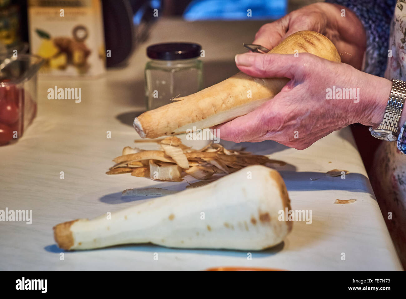 Preparing parsnips for eating in a kitchen Stock Photo - Alamy