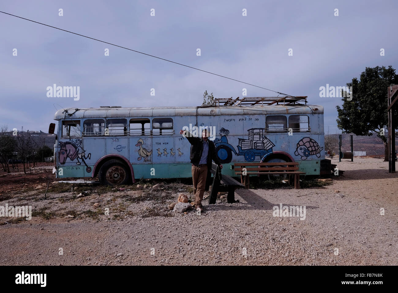 Aharon Katsof a Jewish settler stands in front of a bus that served as ...