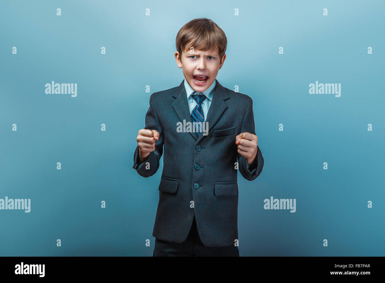 a boy of twelve European appearance in a suit shouting angry o Stock ...