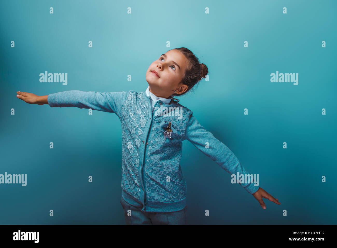 teen girl seven years shows a flying hands on a gray backgrou Stock ...