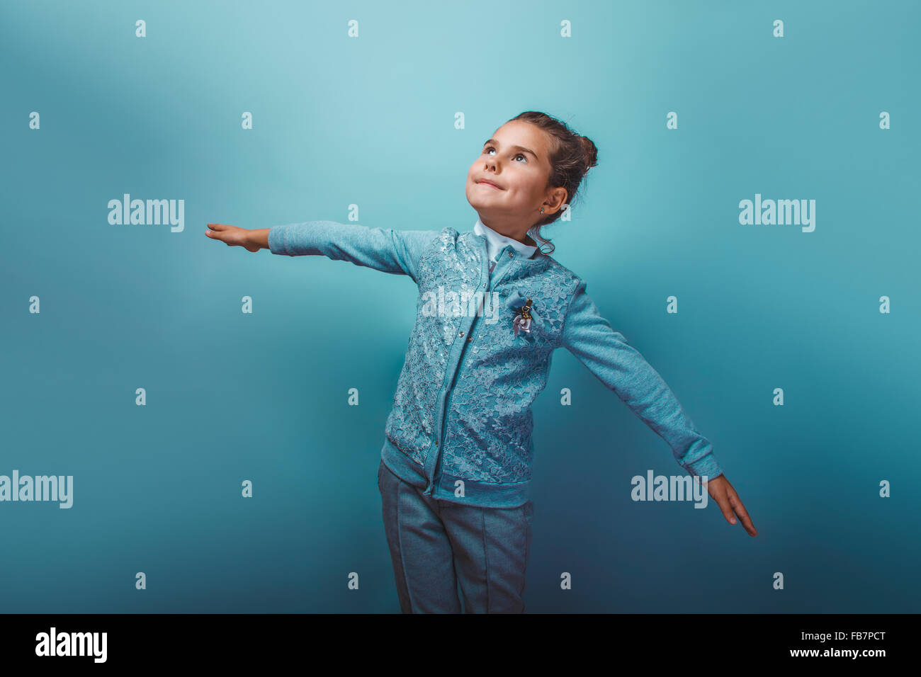 teen girl seven years shows a flying hands on a gray backgroun Stock ...
