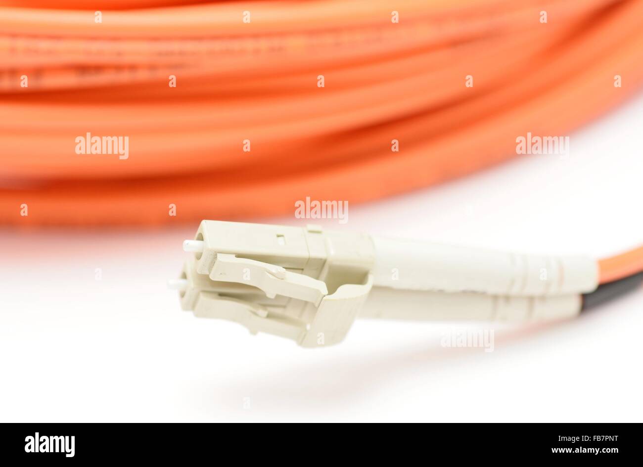 Closeup of the optical fiber cable and LC connector on a white ...