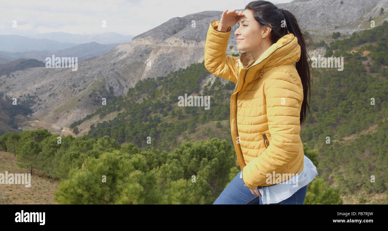 Young woman peering into the distance Stock Photo - Alamy