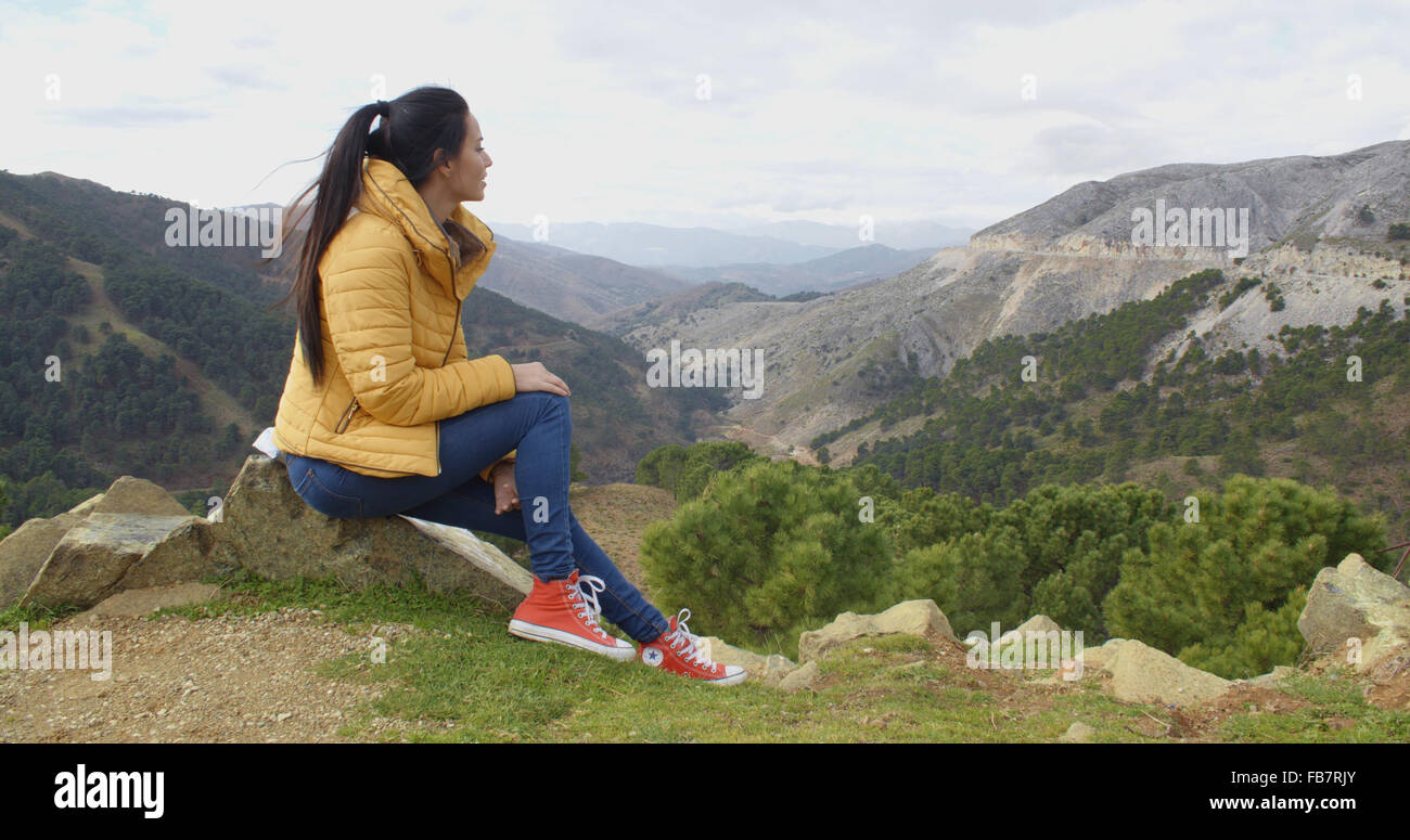 Calm woman looking into valley Stock Photo - Alamy