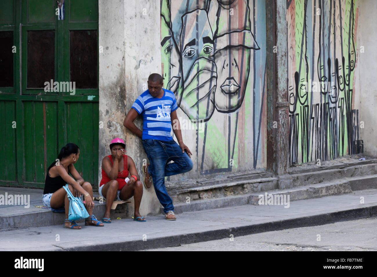 People talking near political mural, Havana, Cuba Stock Photo - Alamy