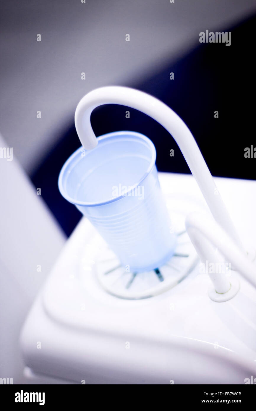 Dentists dental rinse tap and cup in clinic photo Stock Photo - Alamy