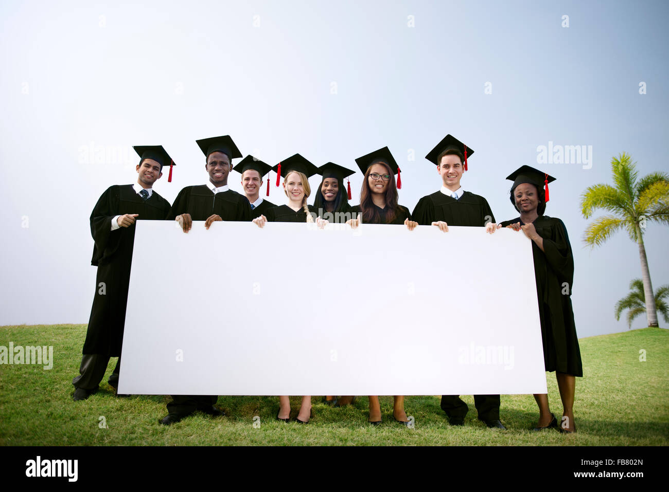 Group Graduating Students Outdoors Holding Placard Concept Stock Photo ...