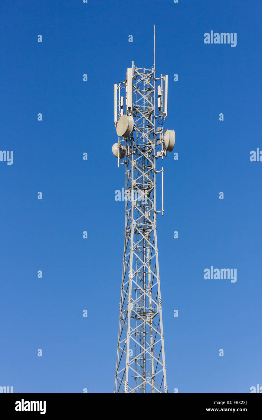 Telecommunication tower with antennas with blue sky Stock Photo - Alamy