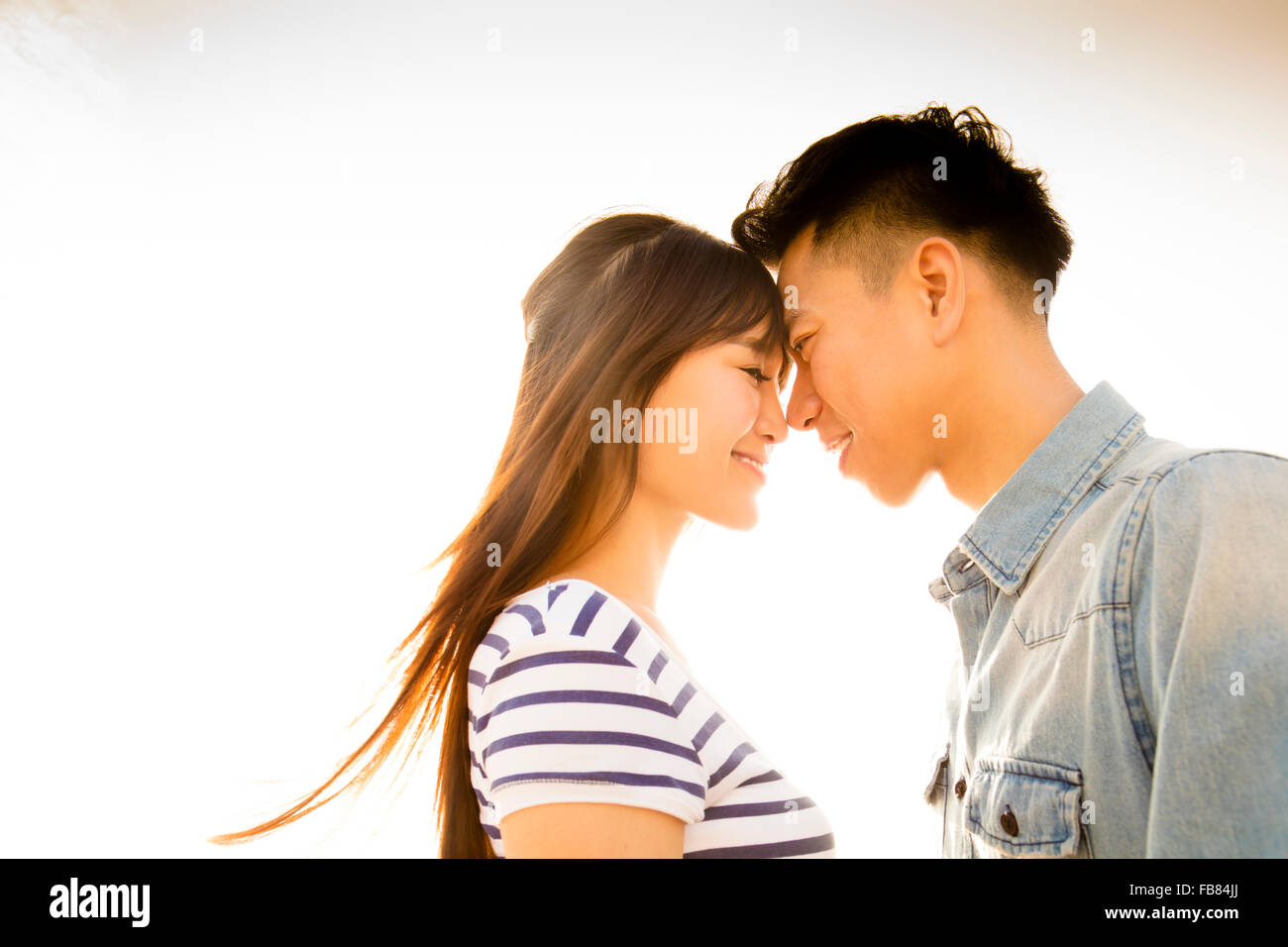 Smiling Couple in love with sunlight background Stock Photo - Alamy