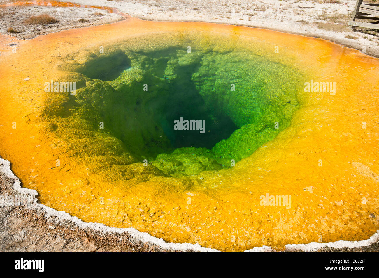 Closeup of bright orange rim and deep green water of the circular ...