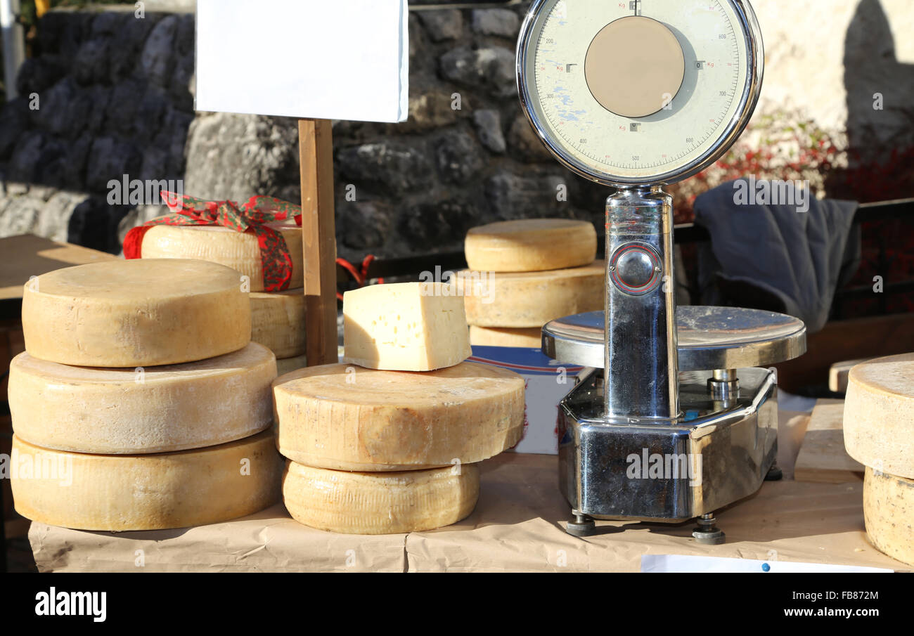 bench of cheese and a balance in the local market Stock Photo - Alamy