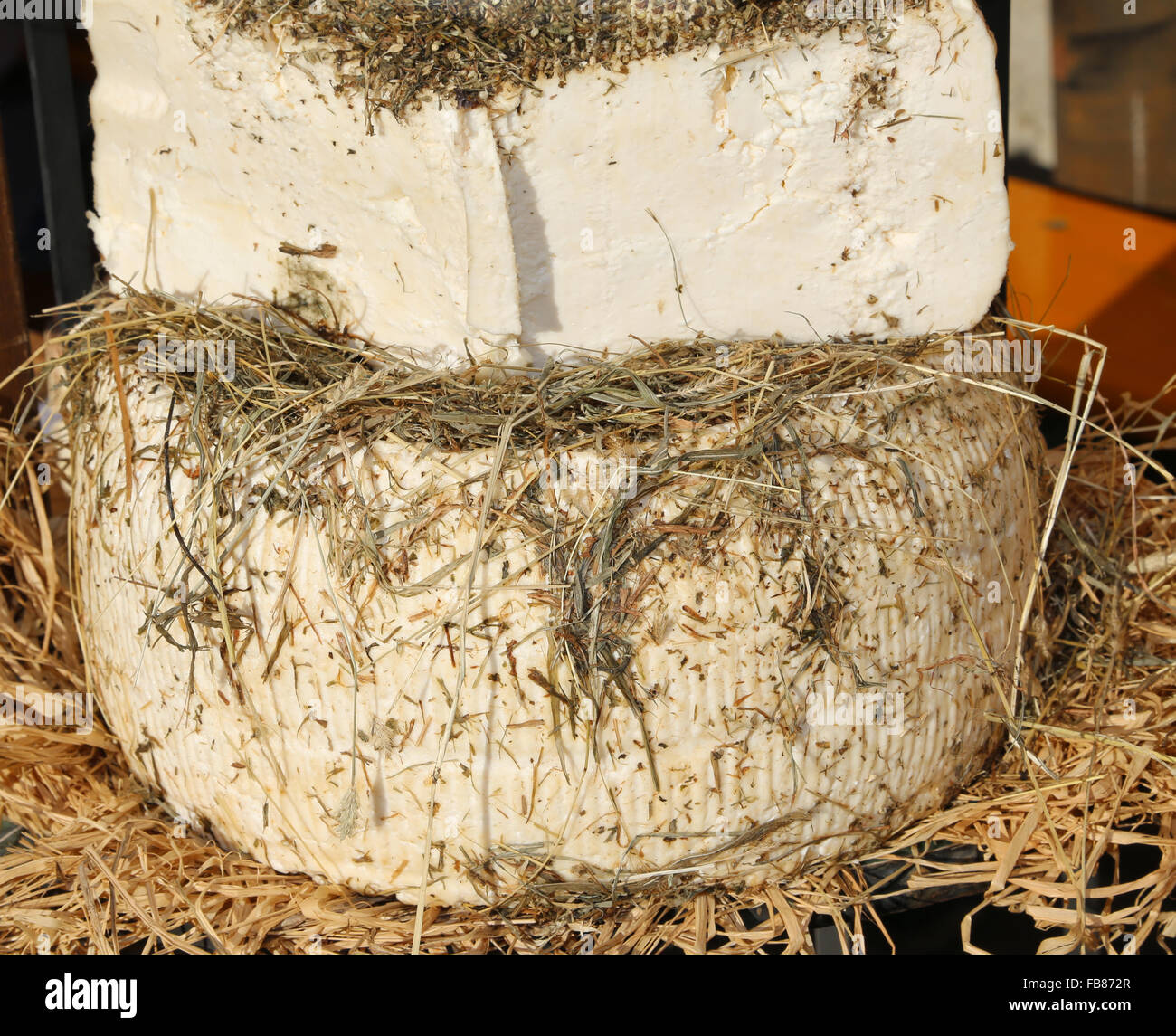 genuine italian cheese is aged between hay and straw Stock Photo - Alamy