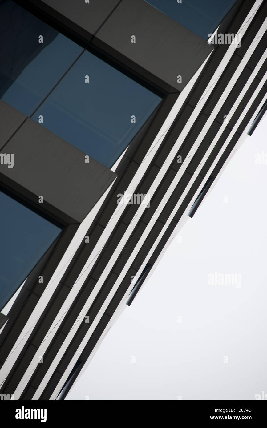 Angled corner of glass and concrete skyscraper Stock Photo - Alamy
