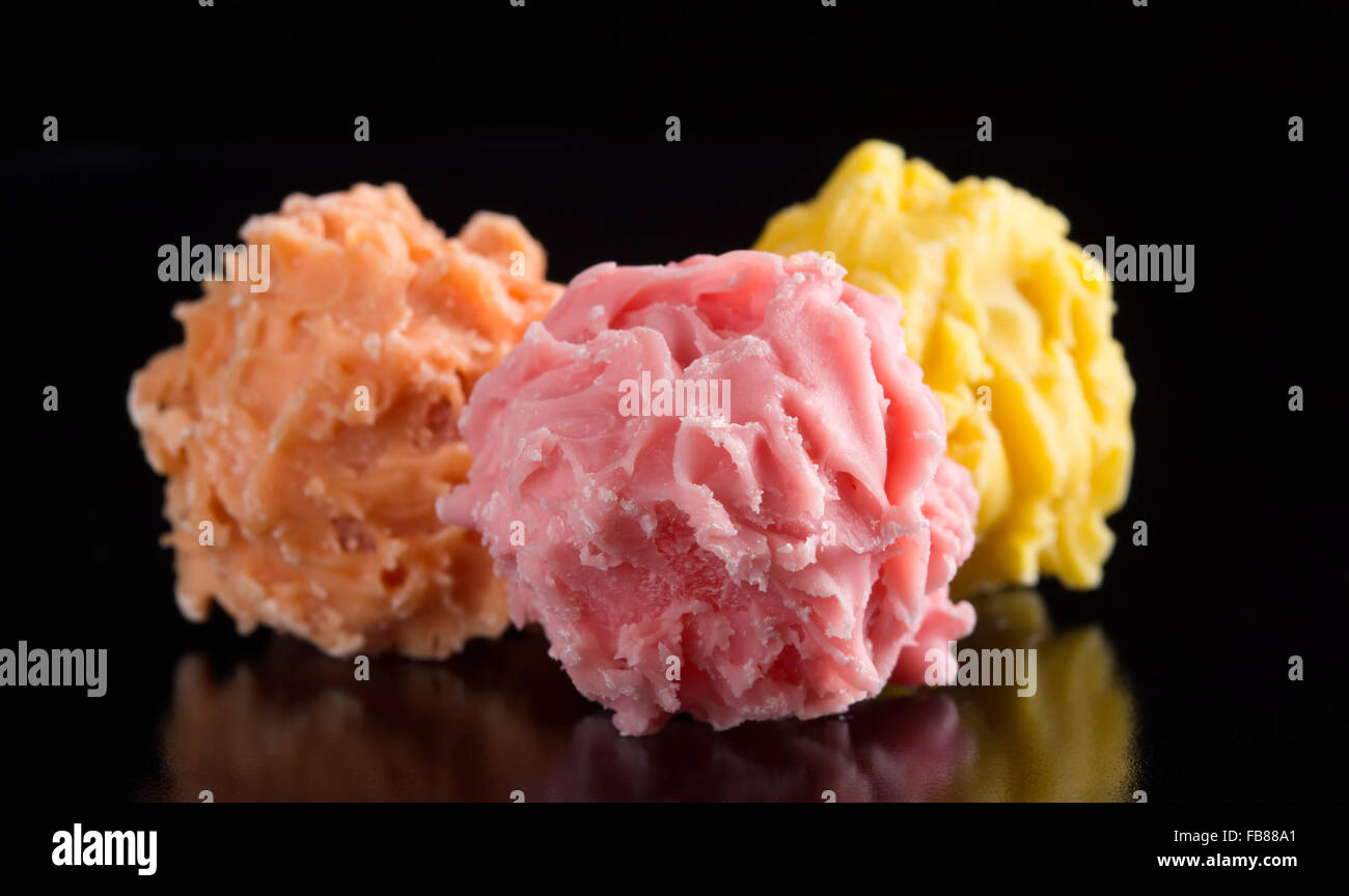 Colorful candies on black background filled with alcohol Stock Photo ...