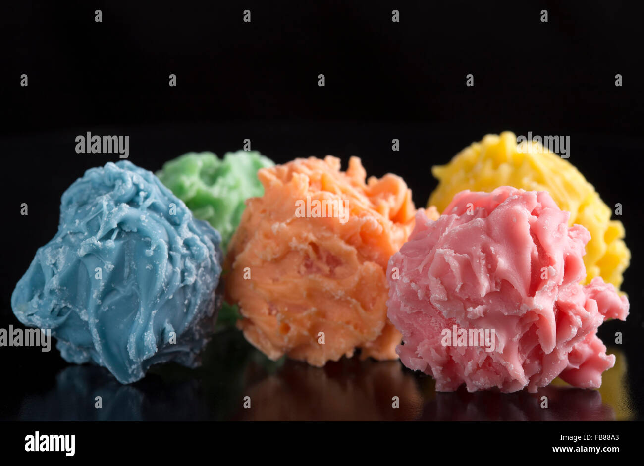 Colorful candies on black background filled with alcohol Stock Photo ...