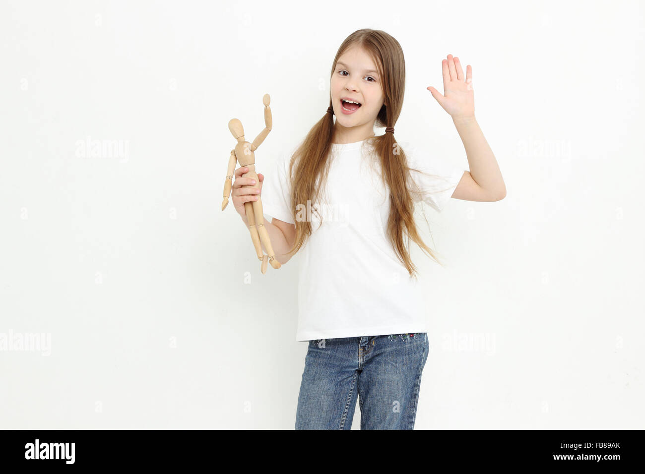 European little girl holding toy man Stock Photo - Alamy