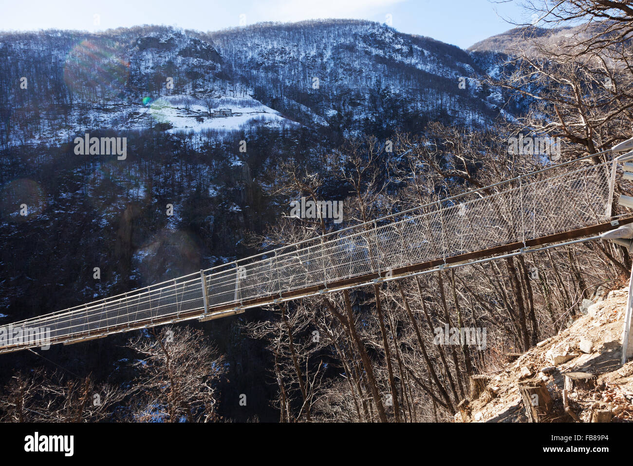 Mountain landscape with suspension bridge over the valley Stock Photo ...
