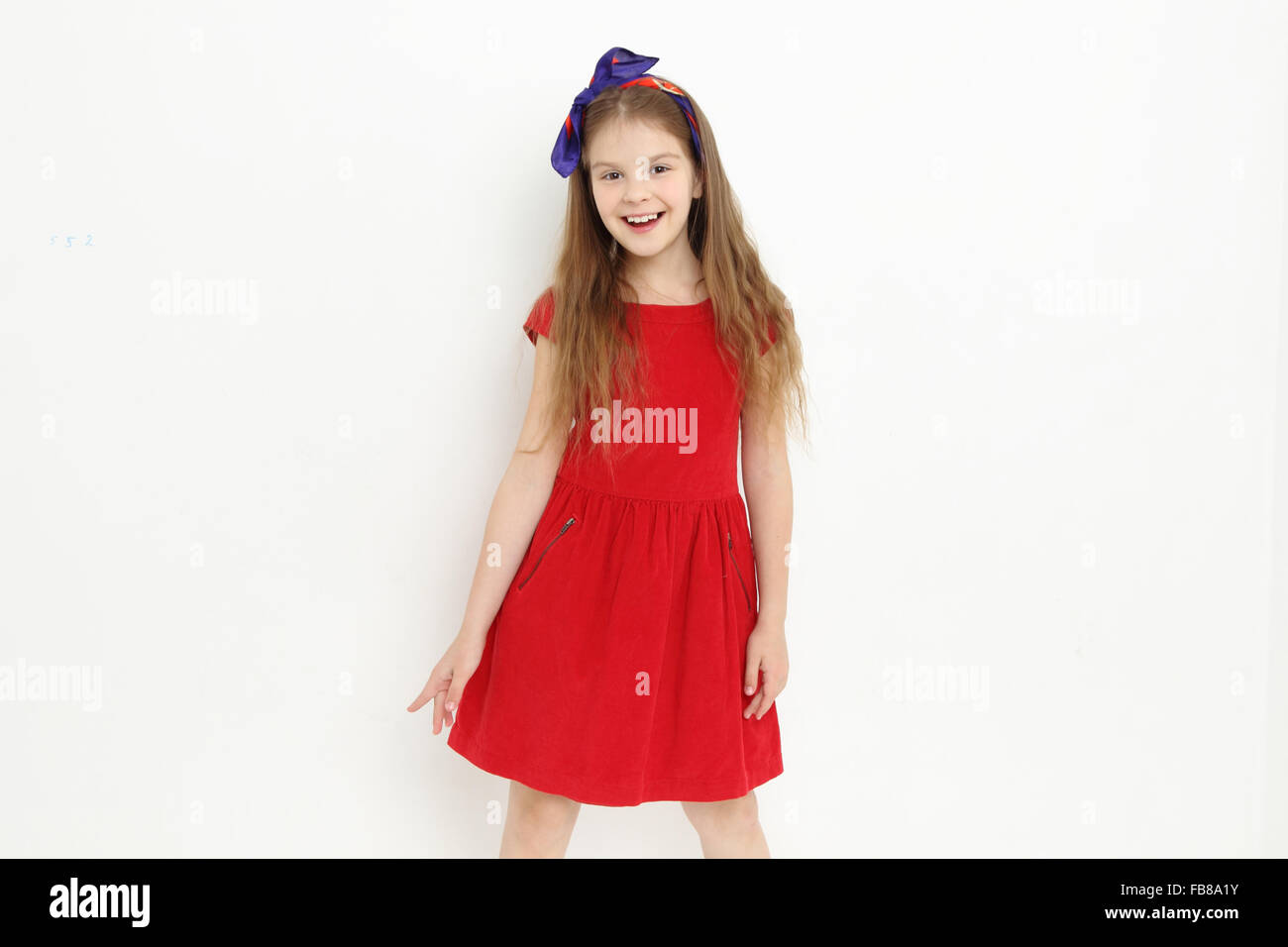 Smiley happy little lady in red Stock Photo - Alamy
