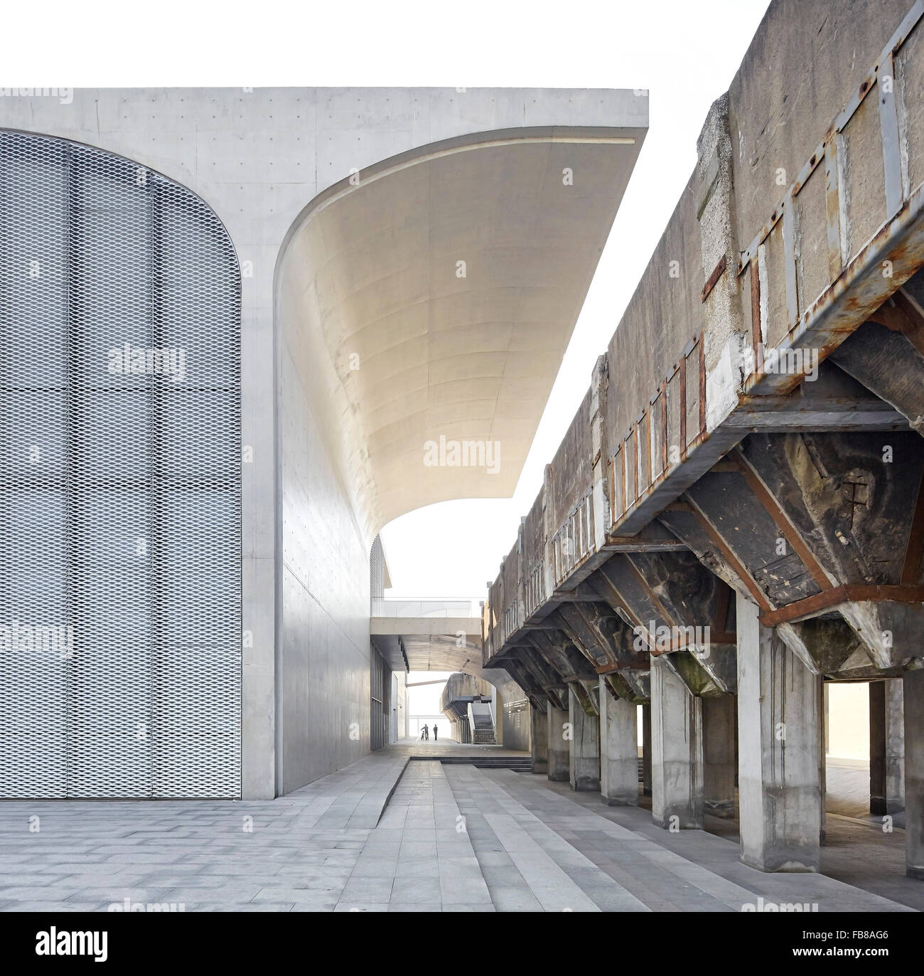 Vaulted concrete columns juxtaposed to derelict loading structure. Long ...