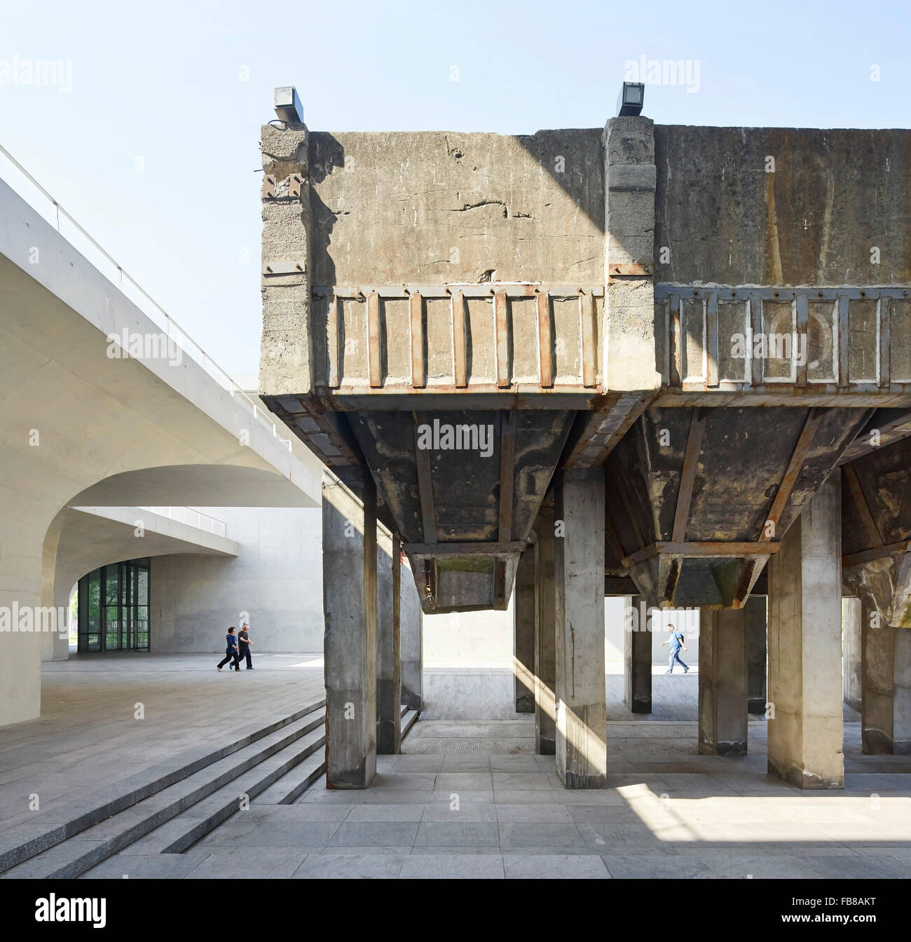 Vaulted concrete columns juxtaposed to derelict loading structure. Long ...
