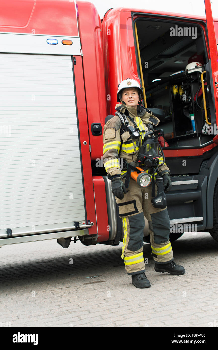 Sweden, Female firefighter by fire engine Stock Photo - Alamy