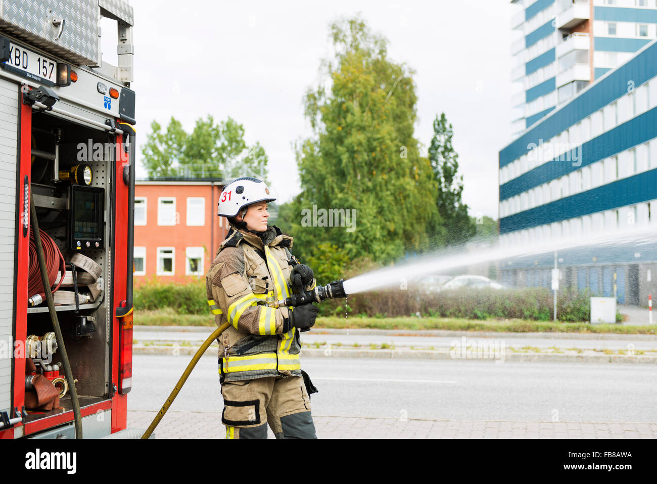 Firefighter hose truck hi-res stock photography and images - Alamy