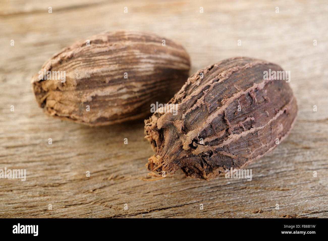 black cardamom on wooden background Stock Photo - Alamy
