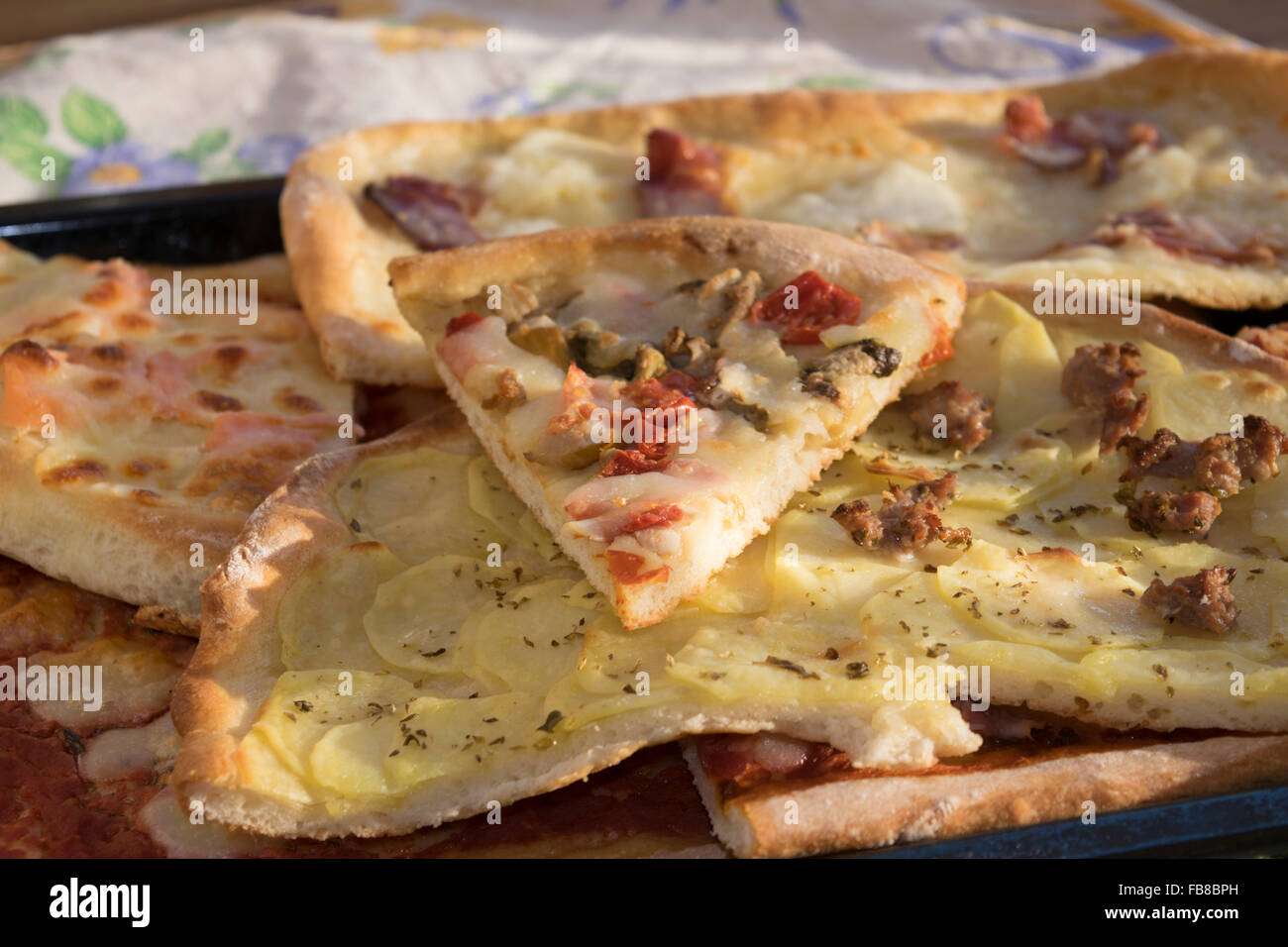 variety of homemade pizza cut in small pieces Stock Photo - Alamy