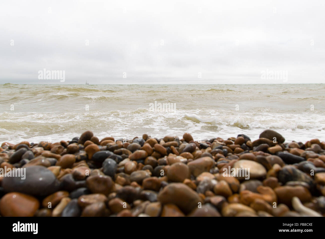 Sea waves washes over pebbles on British shingle coastline beach Stock ...