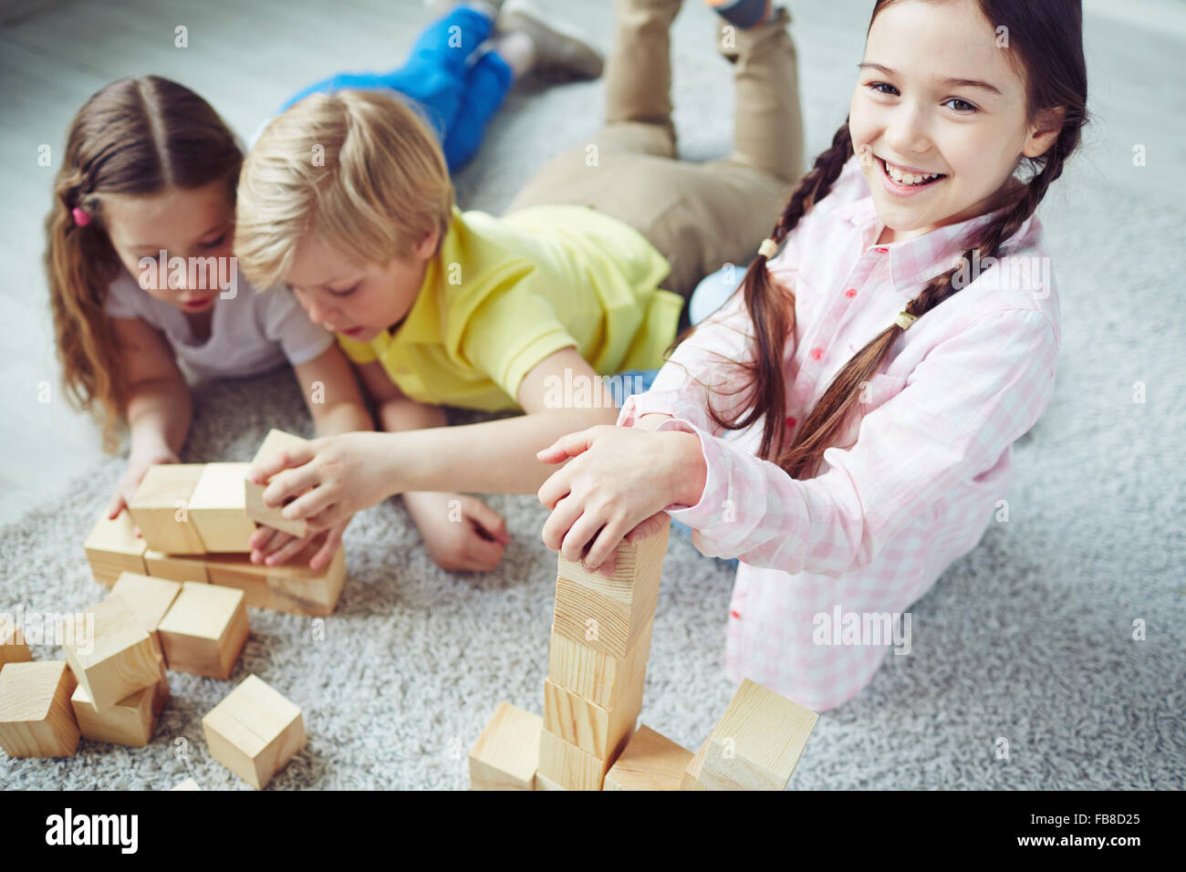 Children playing wooden blocks together at home Stock Photo - Alamy