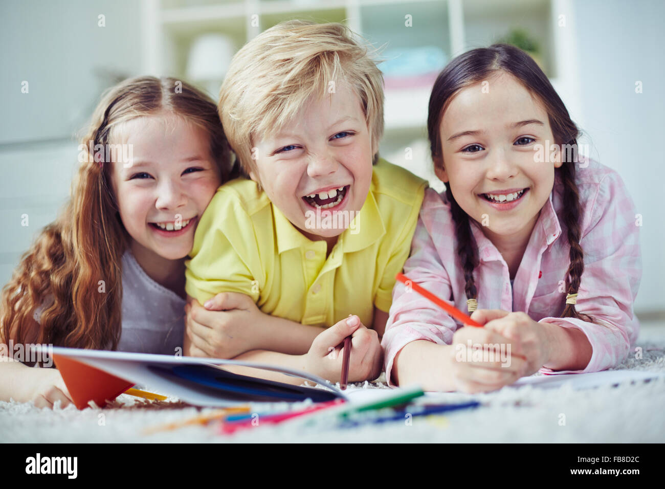 Portrait of cheerful children laughing while drawing Stock Photo - Alamy