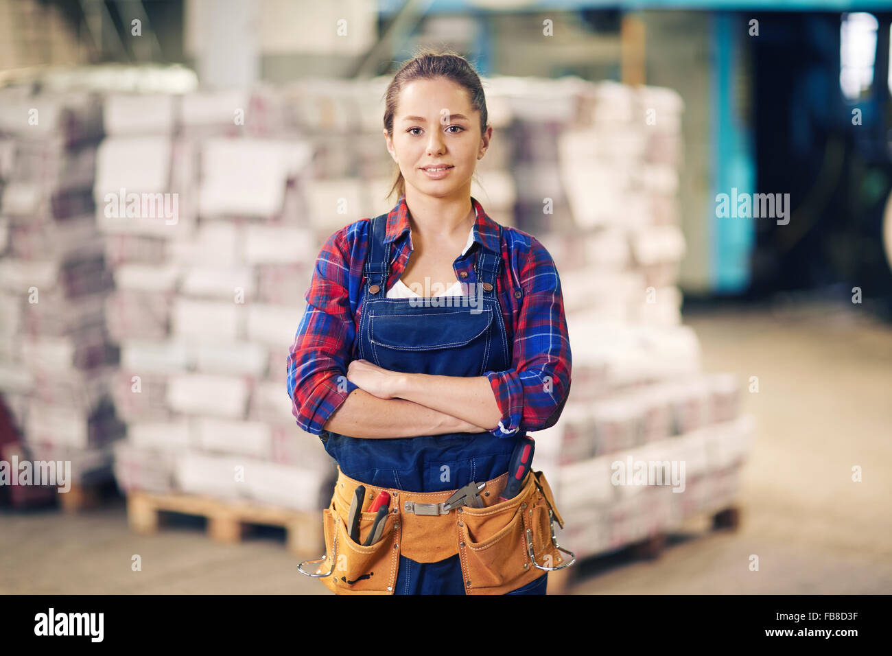 Manual worker standing in warehouse Stock Photo - Alamy