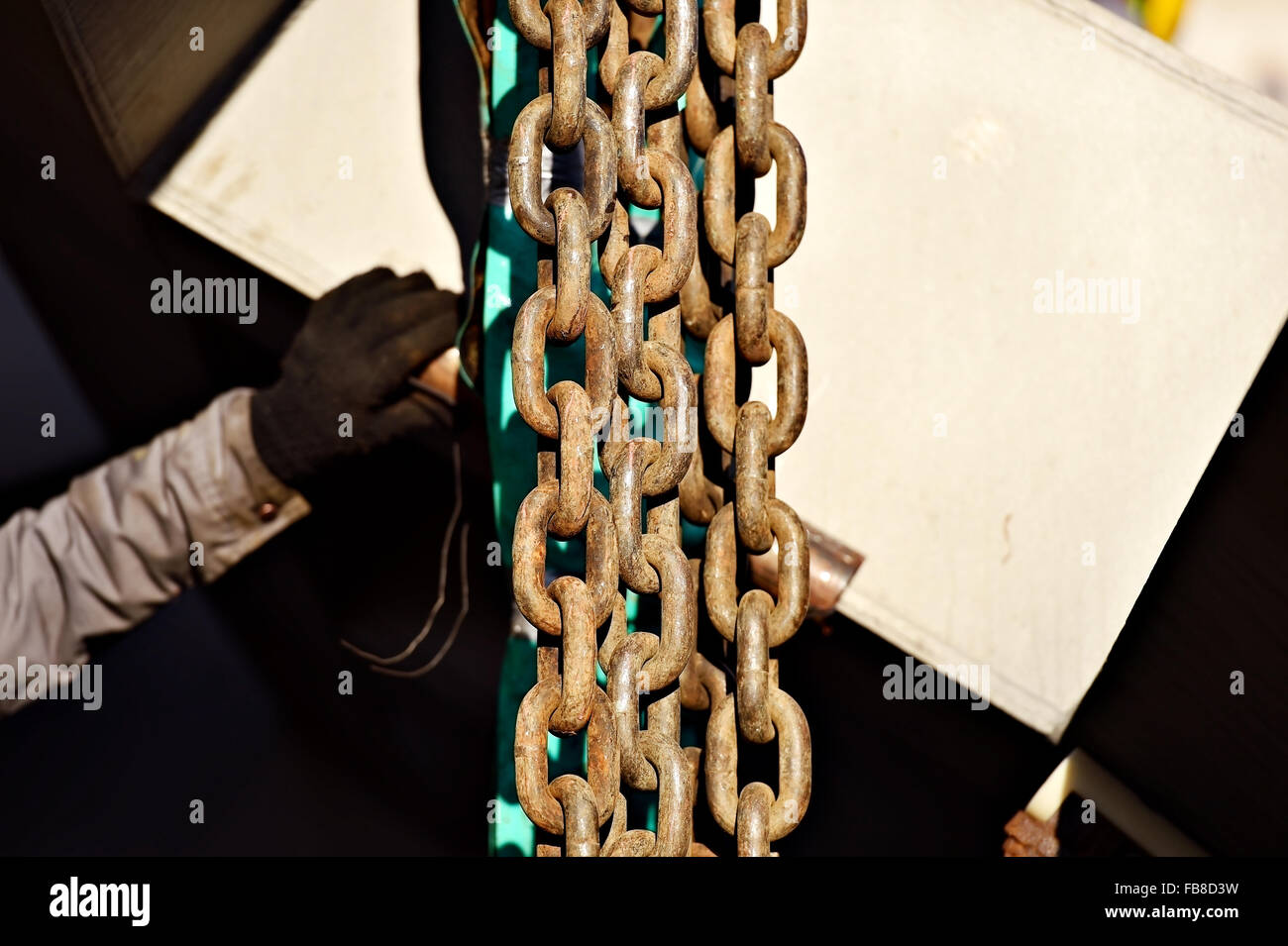 Construction worker hand near a heavy duty industrial chain Stock Photo ...