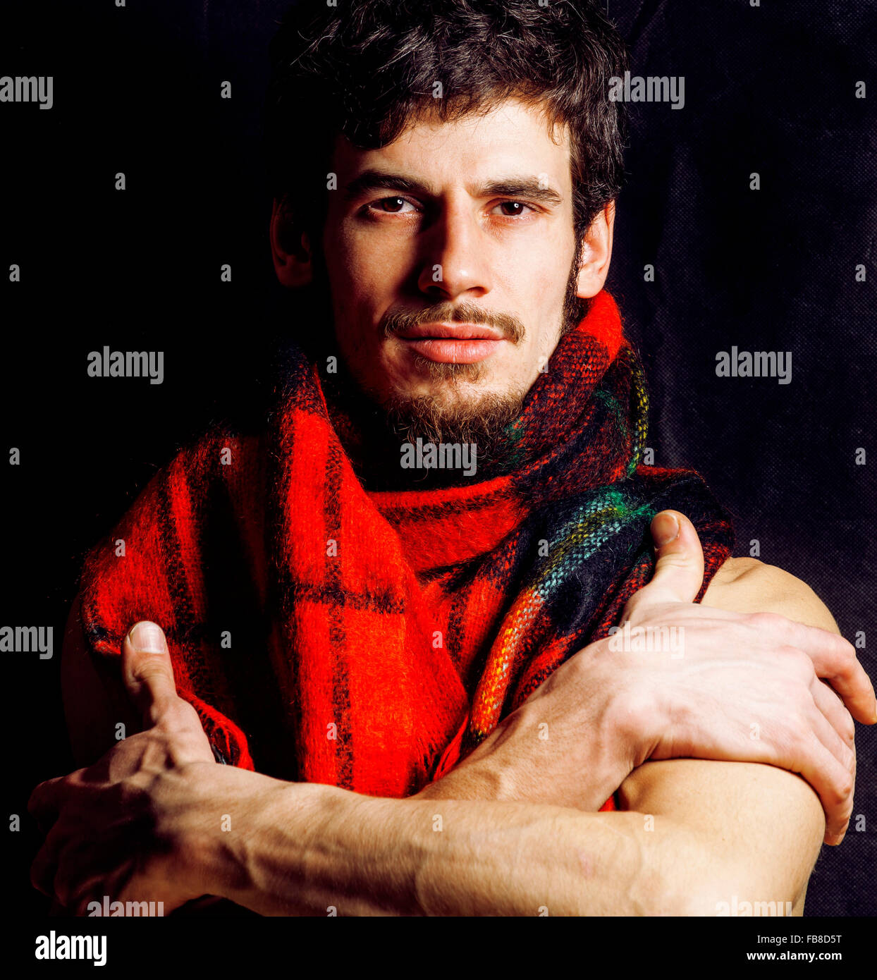portrait of handsome man warmed up in scarf, smiling closeup dark ...
