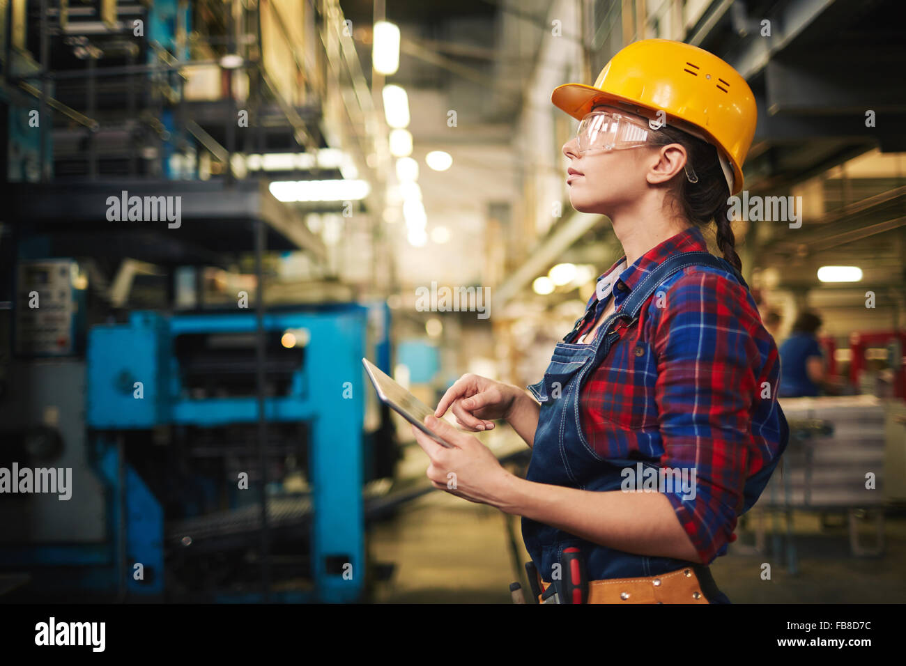 Industrial female inspector worker with touchpad in factory Stock Photo ...