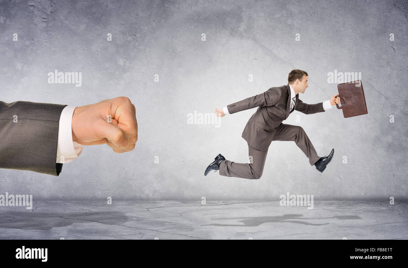 Mans fist and running businessman Stock Photo - Alamy