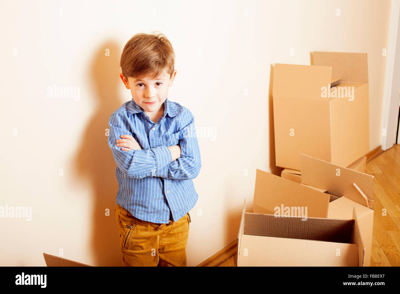 little cute boy in empty room, remoove to new house. home alone emong ...